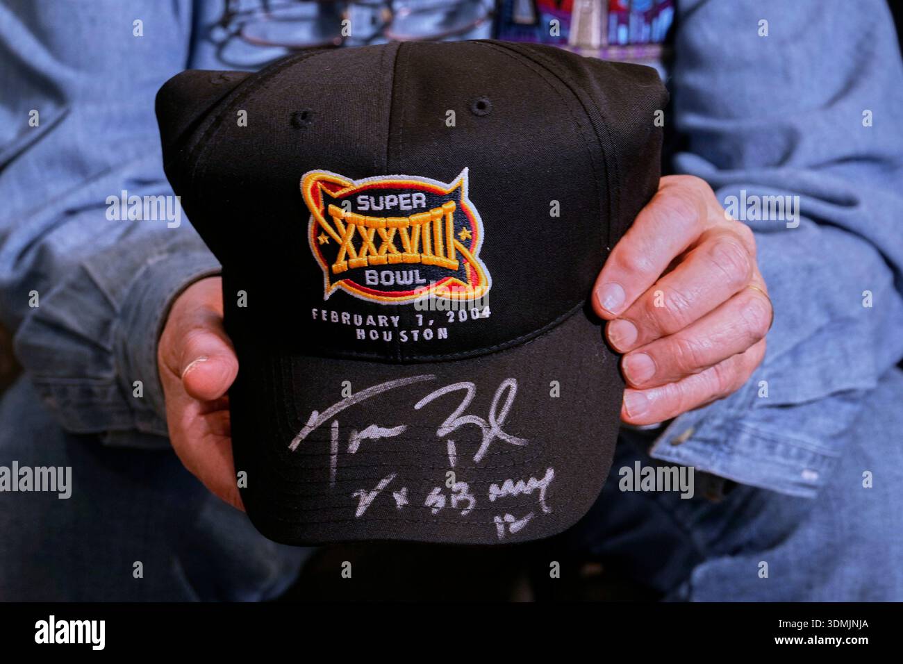 Don Crisman holds a Super Bowl 38 souvenir hat signed by Hall of Fame ...
