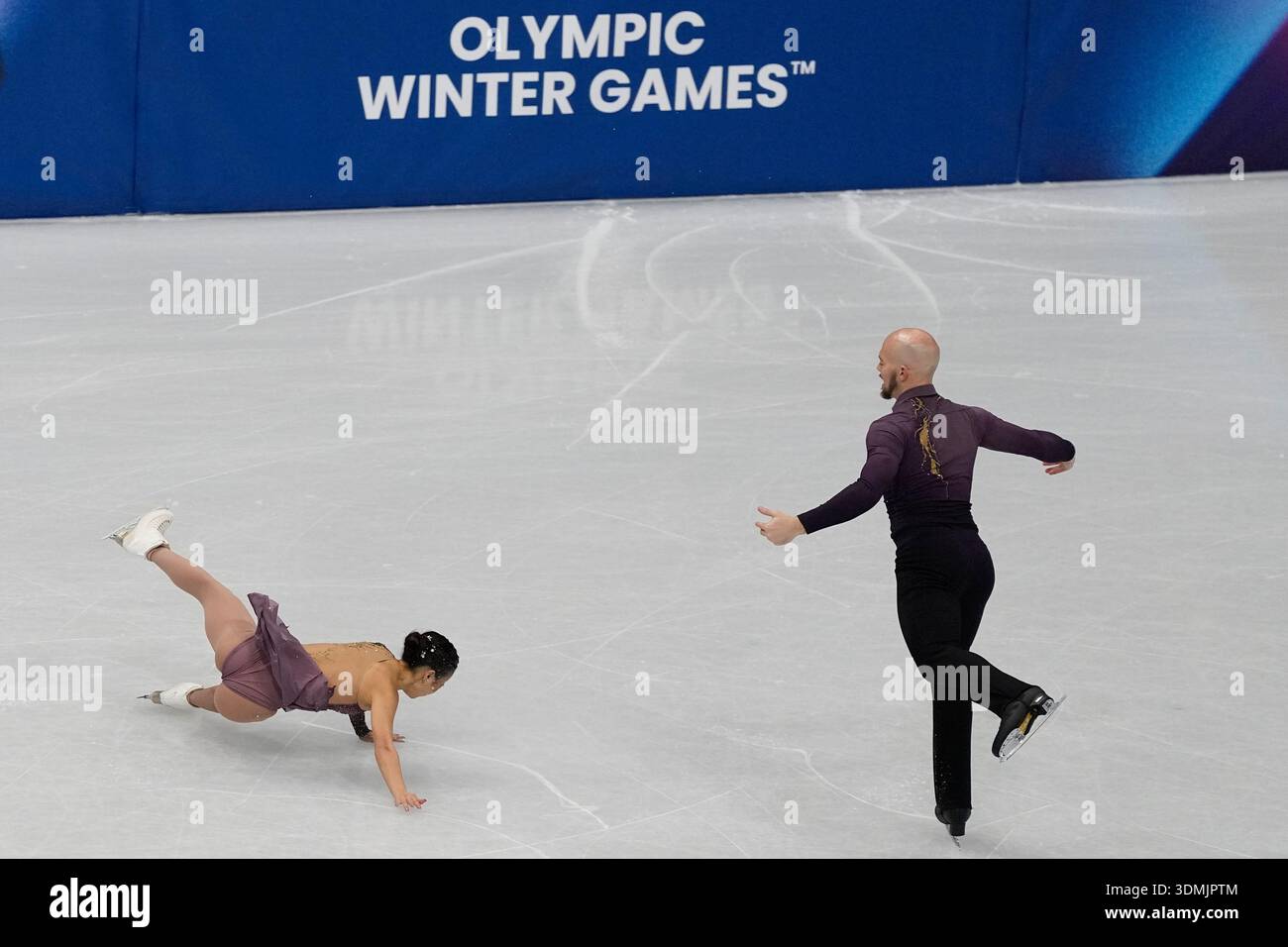Ellie Kam falls while competing with her partner Danny O'Shea of the ...