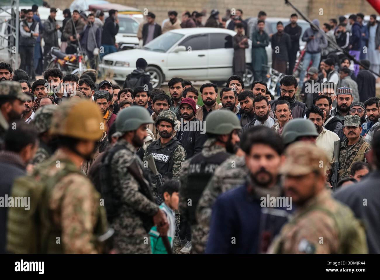 Pakistani paramilitary soldiers control a crowd close to the site of a ...