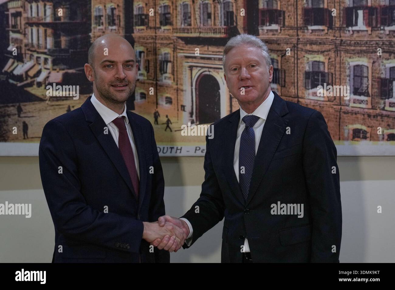 Lebanese Foreign Minister Youssef Rajji, right, shakes hands with his ...