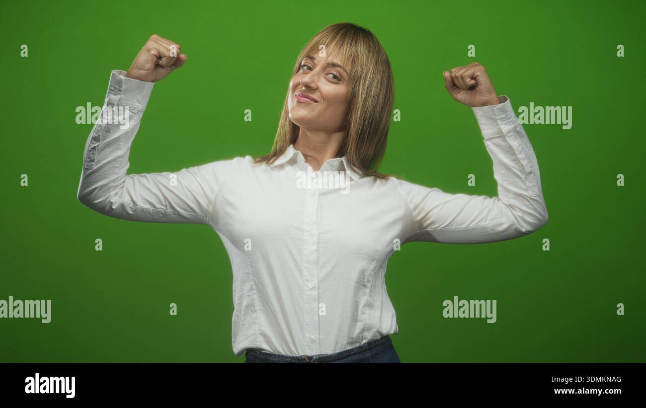 Woman middle age hispanic blonde flexes both arms and clenches fists in ...