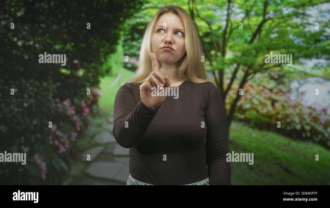 Woman points finger pout hi-res stock photography and images - Alamy