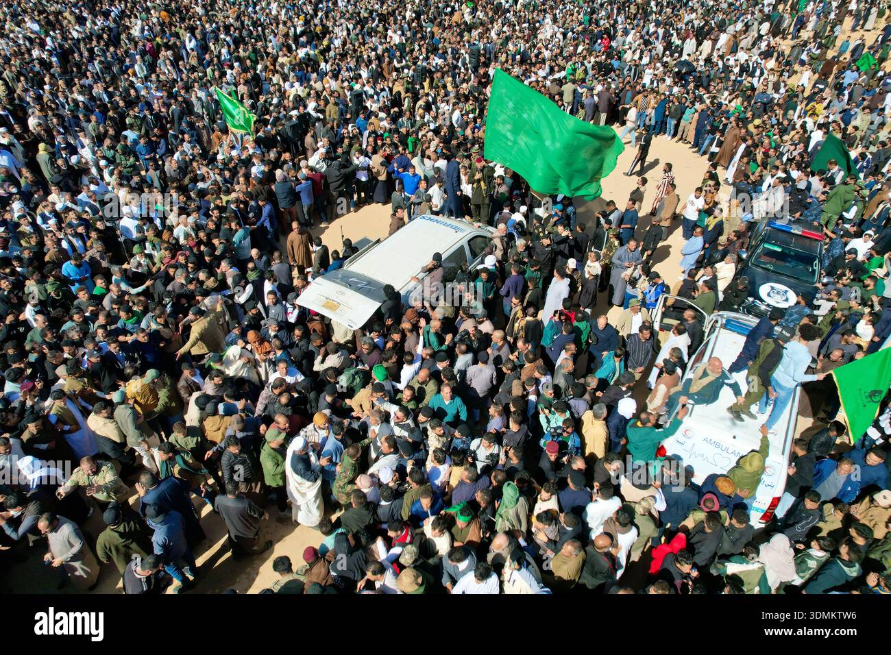 Thousands of Libyans surround an ambulance carrying the coffin of Seif ...
