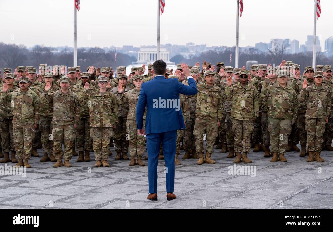 Defense Secretary Pete Hegseth administers the oath of enlistment to a ...