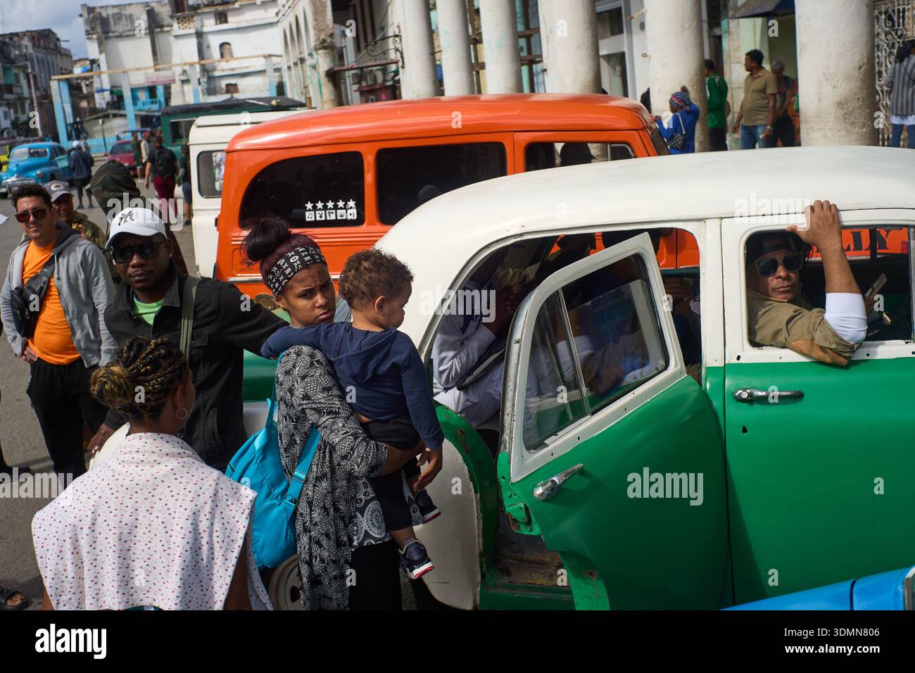 People wait their turns to board shared taxis in Havana, Cuba, Friday ...