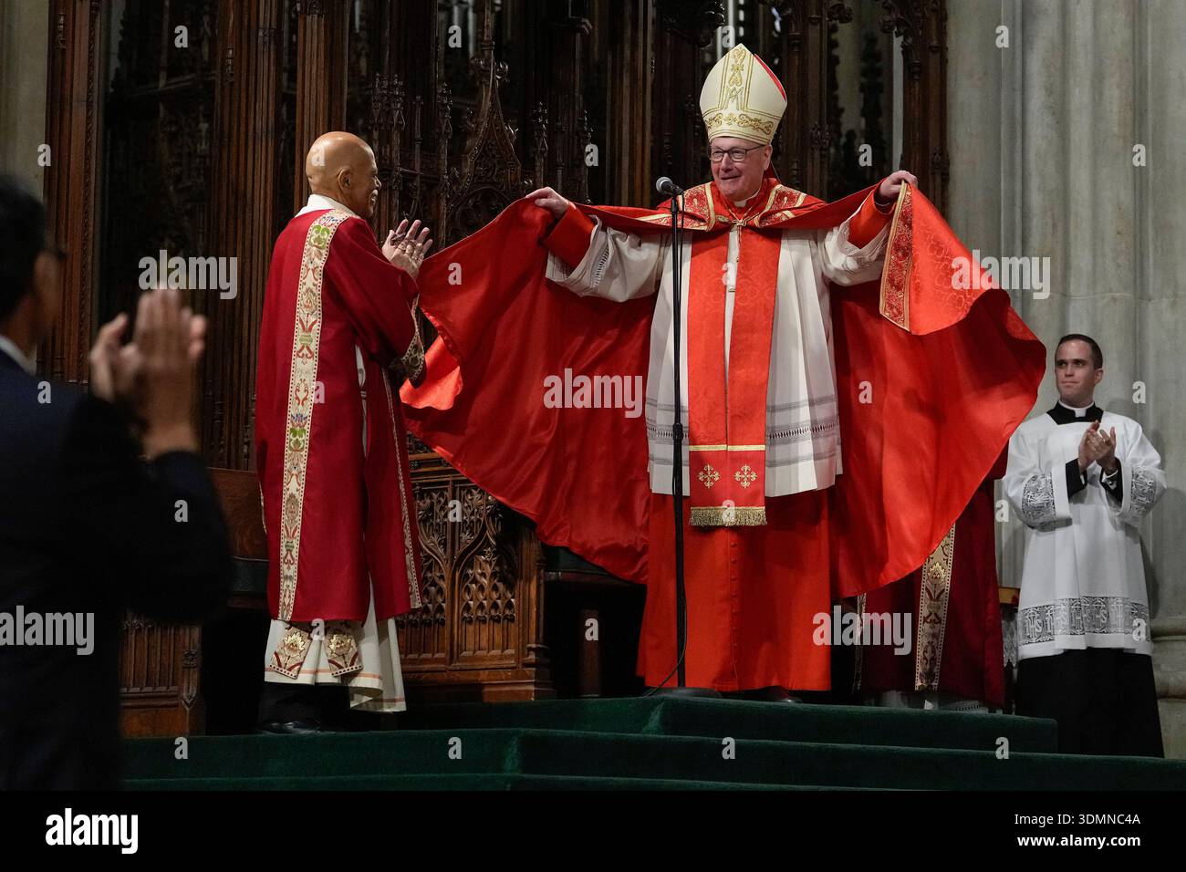 Cardinal Timothy Dolan greets the congregation at the start of the Mass ...