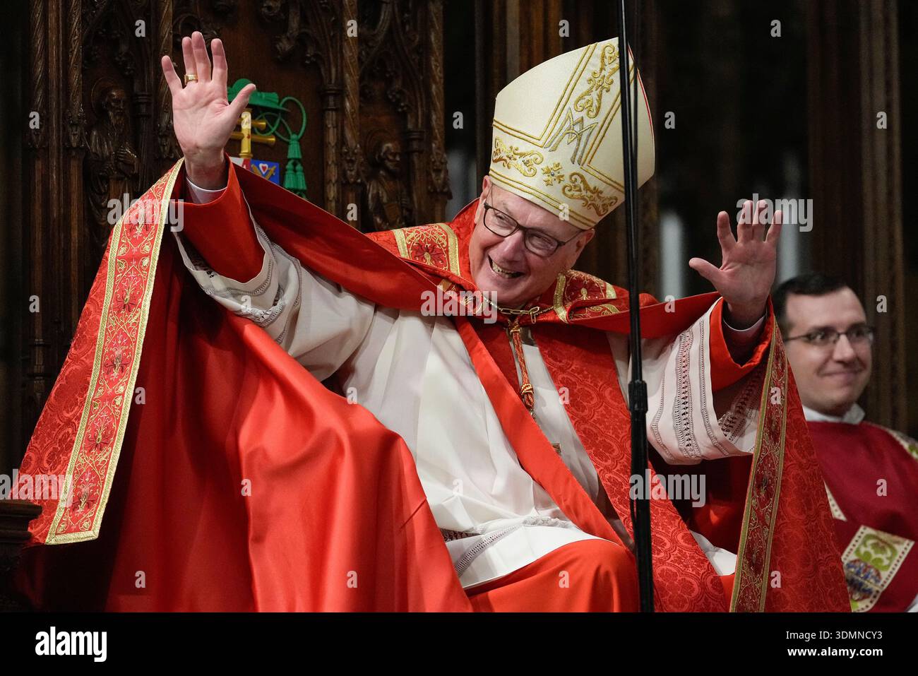 Cardinal Timothy Dolan waves to the congregation during the Mass of ...