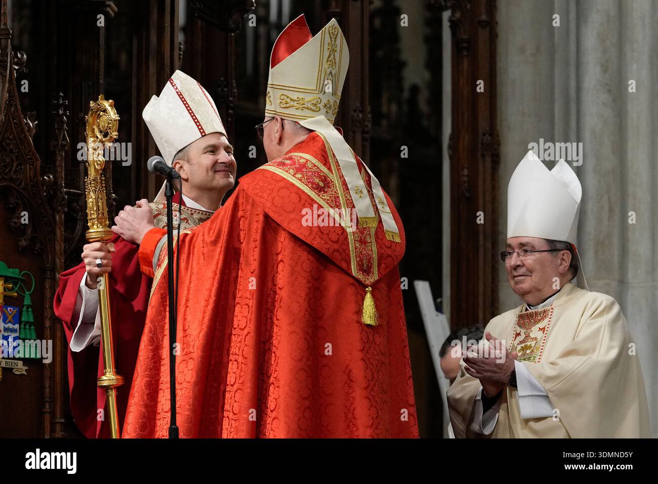 Archbishop Ronald Hicks, left, is greeted by Cardinal Timothy Dolan ...