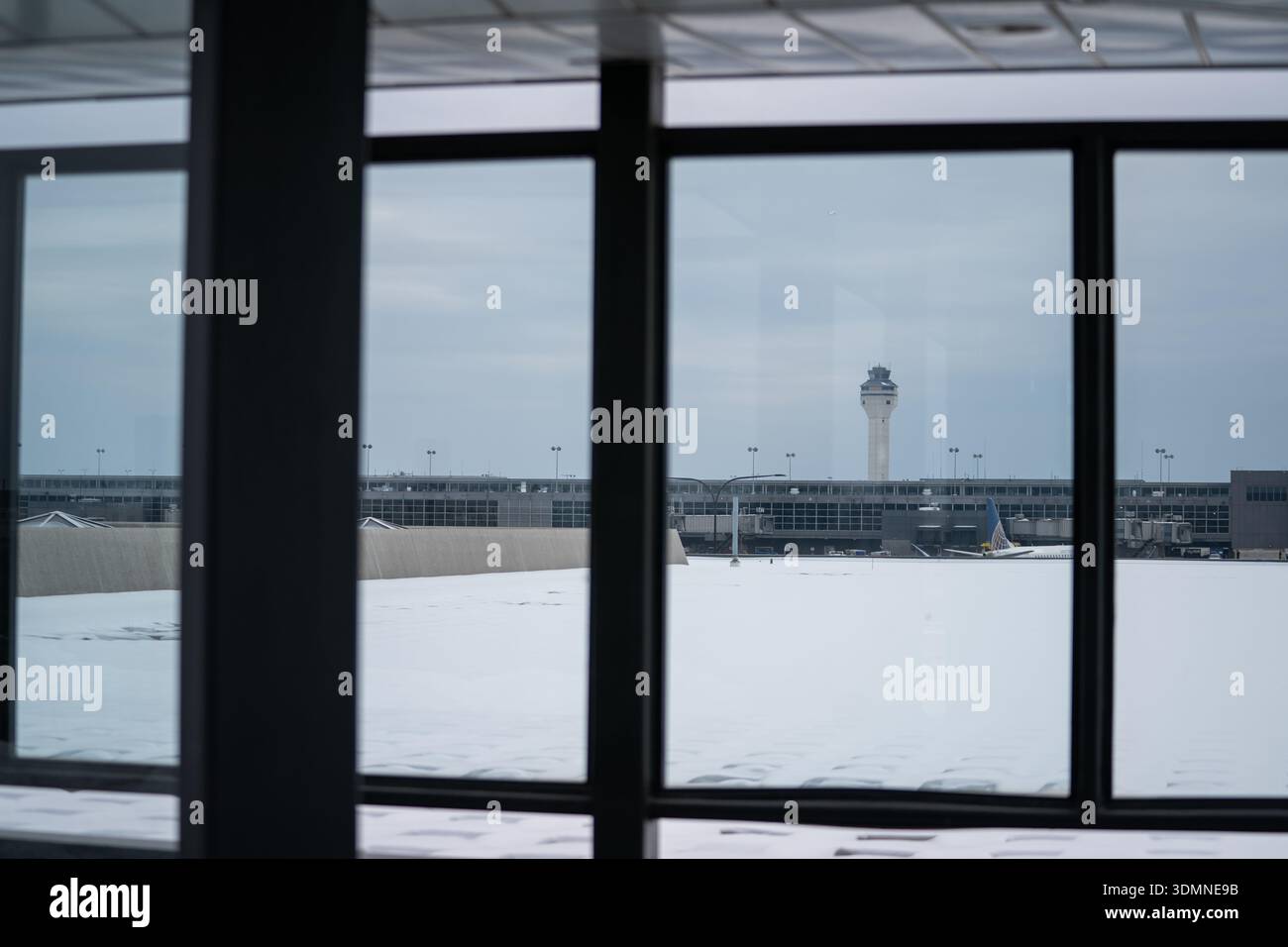 An air traffic control tower is seen through a window at Dulles ...