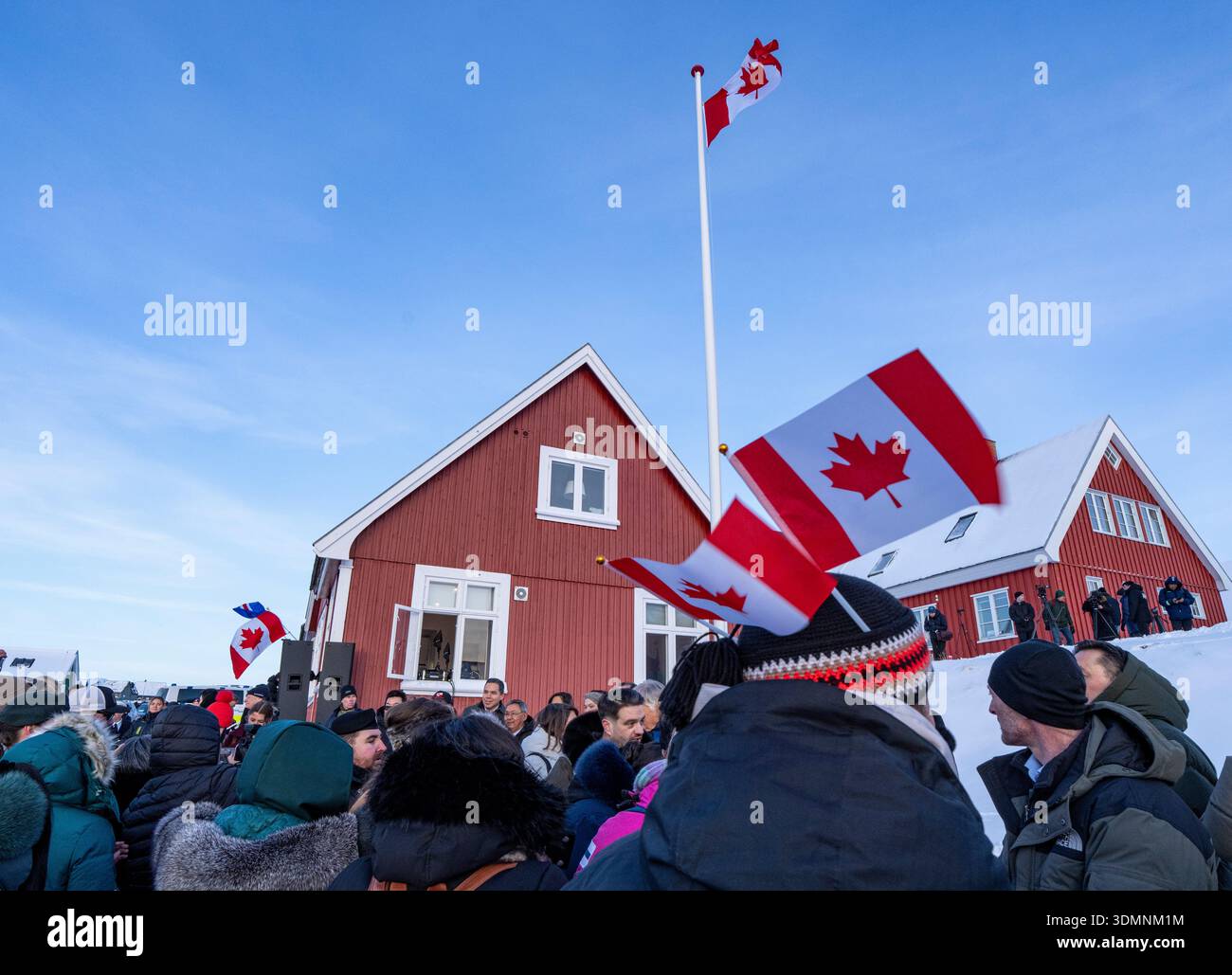 An attendee wears Canadian flags in his hat during the flag raising of ...