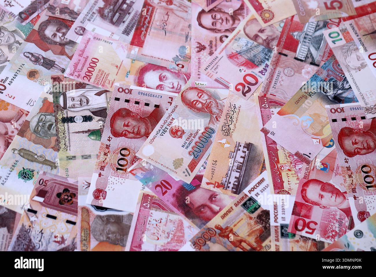 Various currencies money bills banknotes in red color. Many cash bills ...