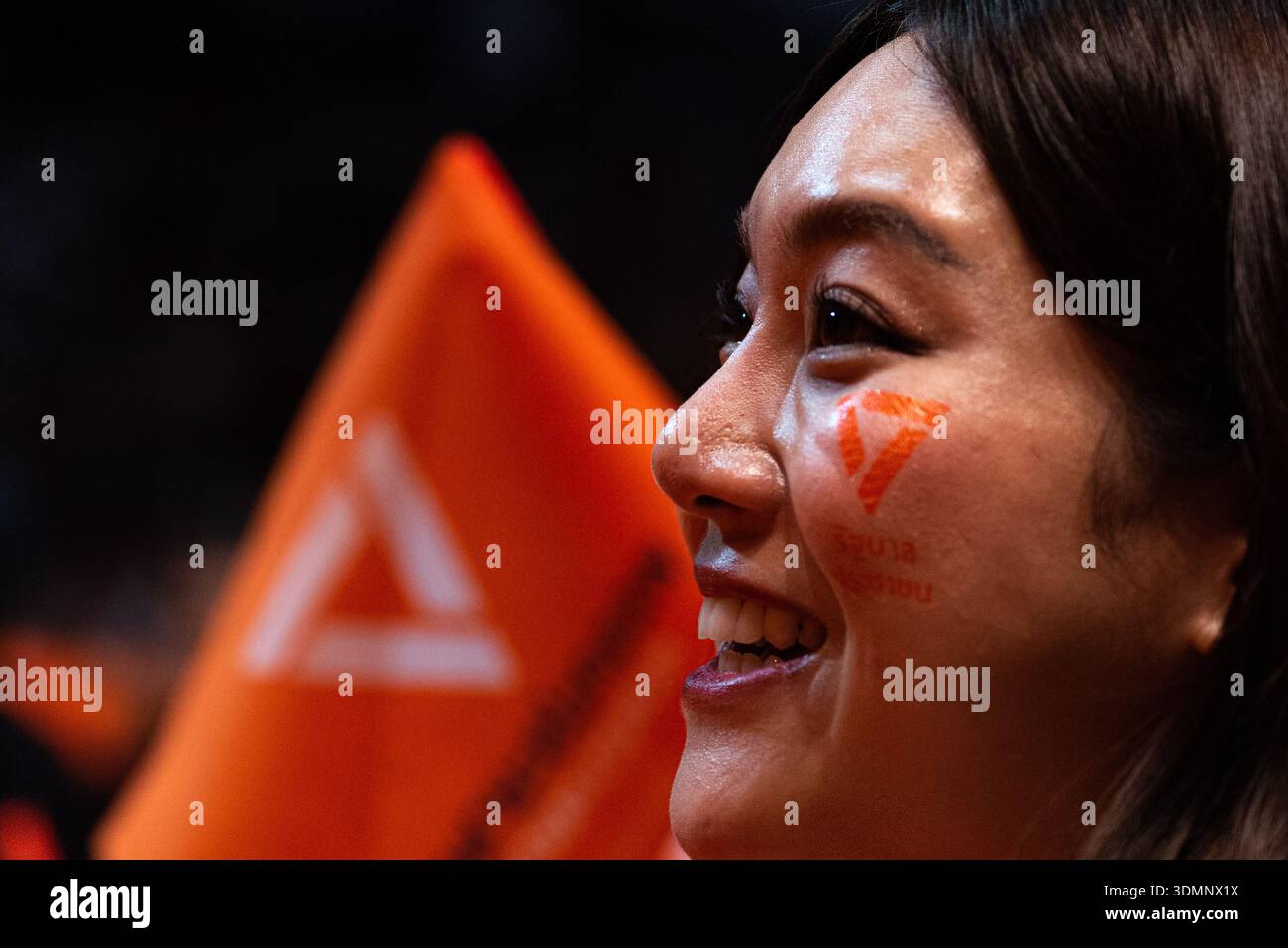 A supporter paints her face with the People's Party's logo during the ...