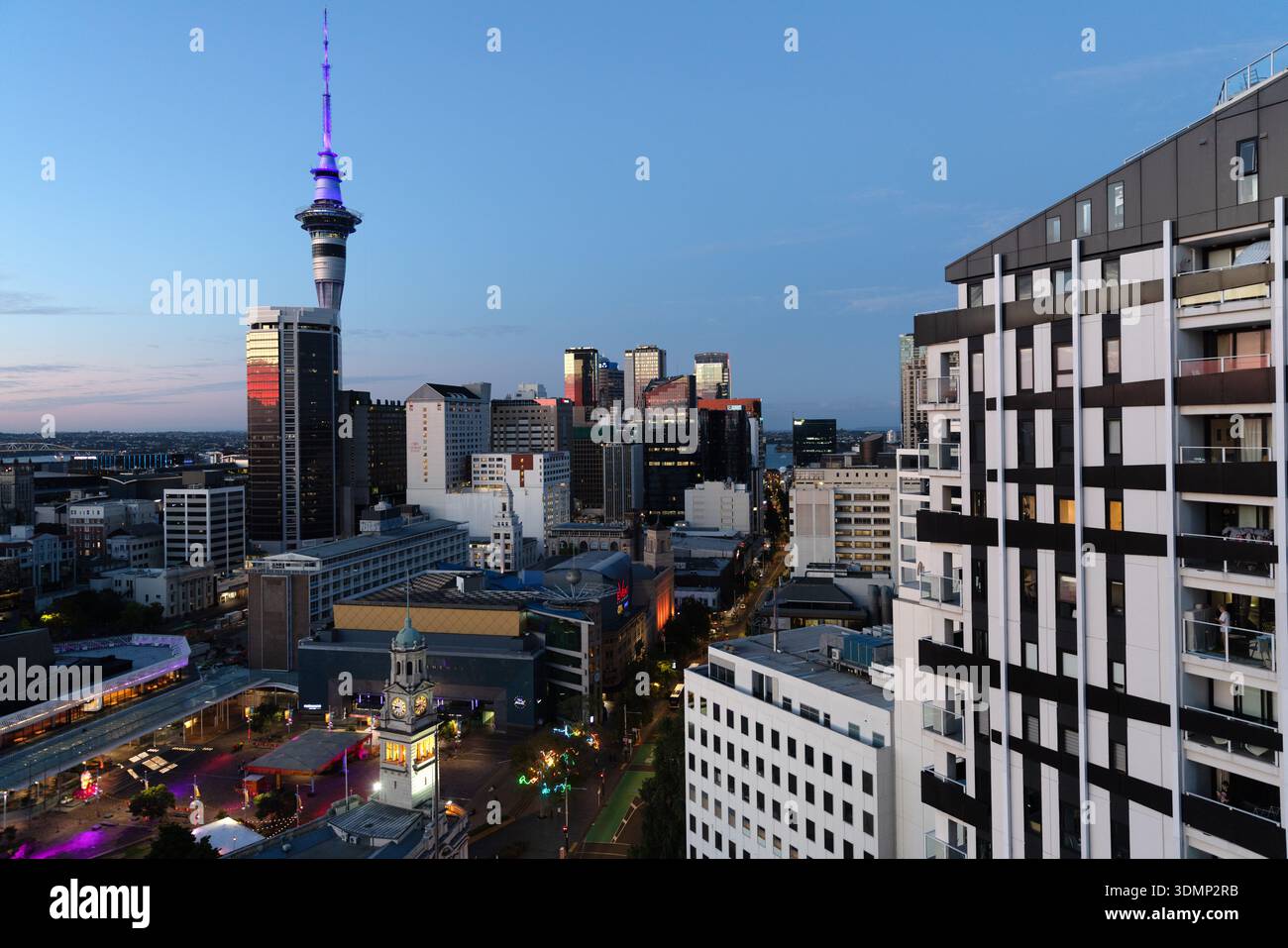 Auckland city skyline at dusk with the Sky Tower illuminated above ...