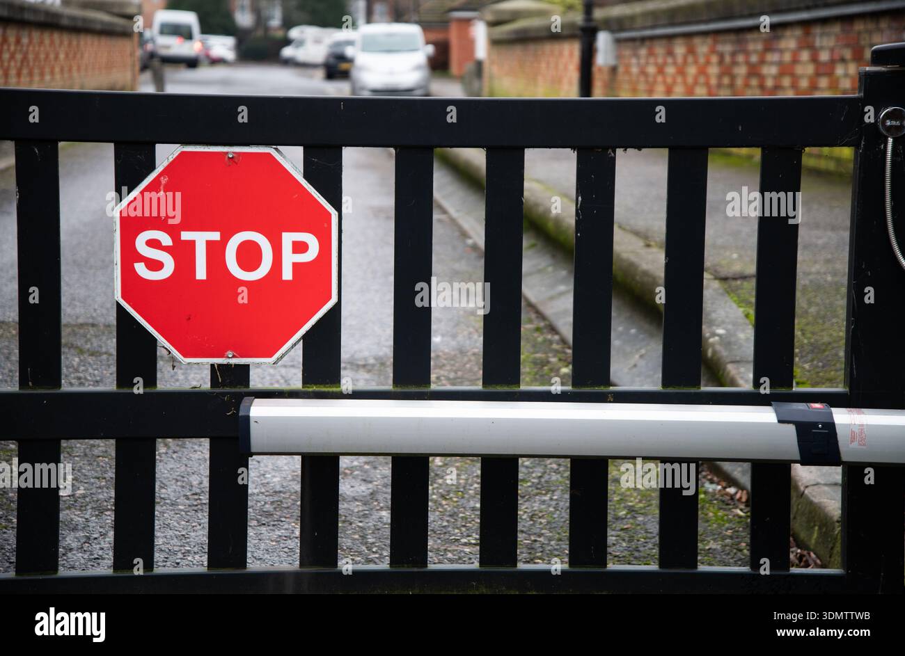 Red stop sign mounted on a road security gate, controlling access and ...