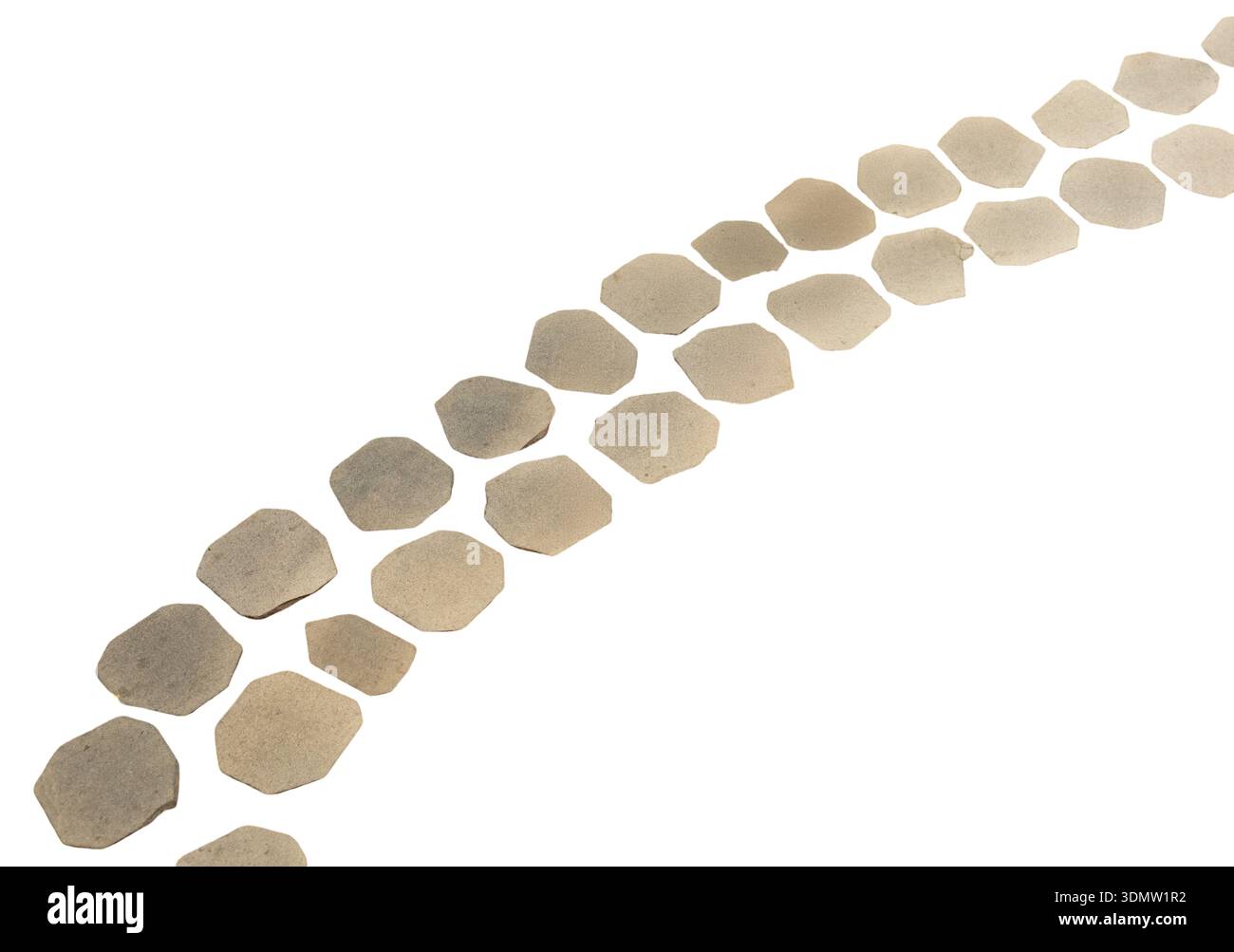 Hexagonal stones are laid out in a curved line. The stones vary in size ...