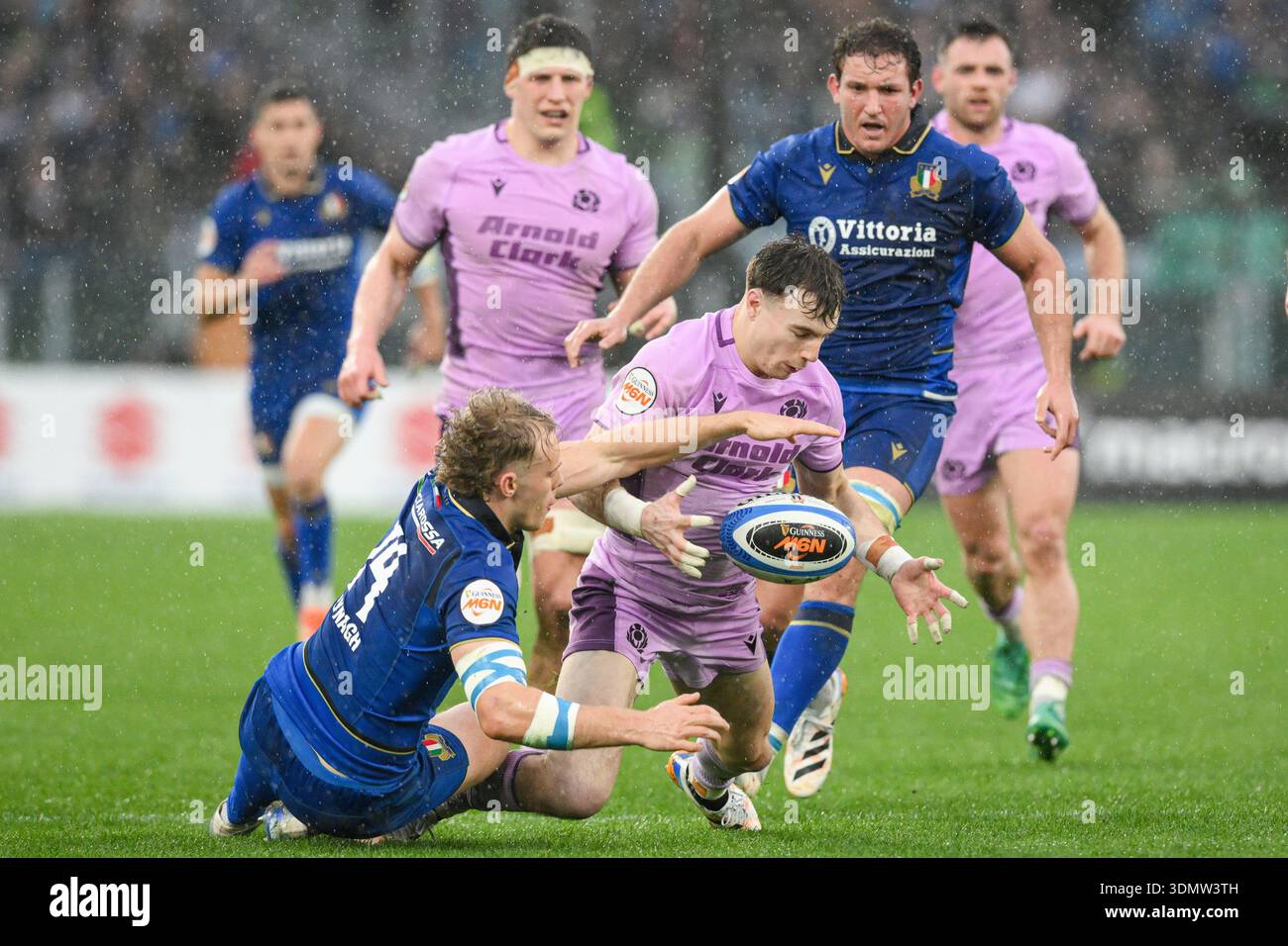Jamie dobie of scotland is tackled louis lynagh of italy hi-res stock ...