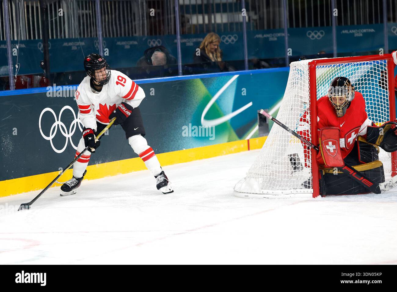 Canada's Brianne Jenner (19) looks to pass the puck as Switzerland goal ...