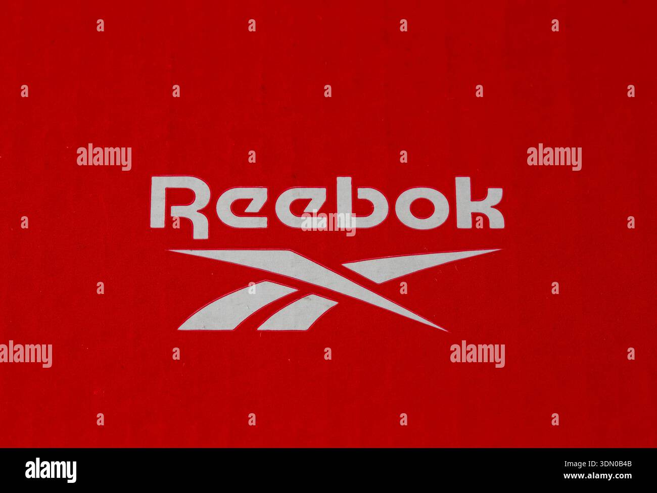 Close-up of the Reebok athletic trainer logo on a vibrant red shoebox ...
