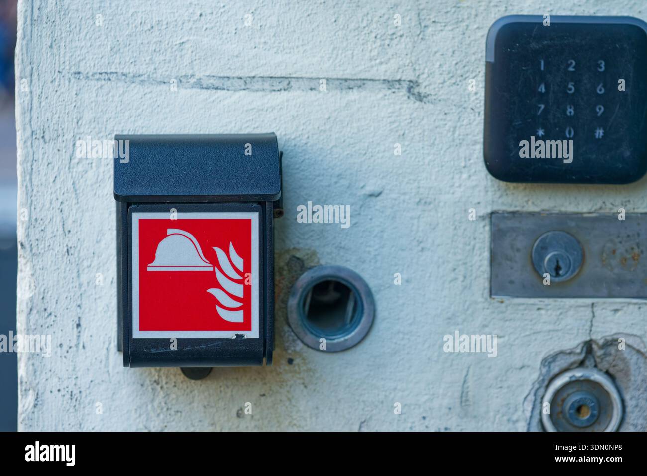 Emergency key box for fire department access mounted on a building wall ...