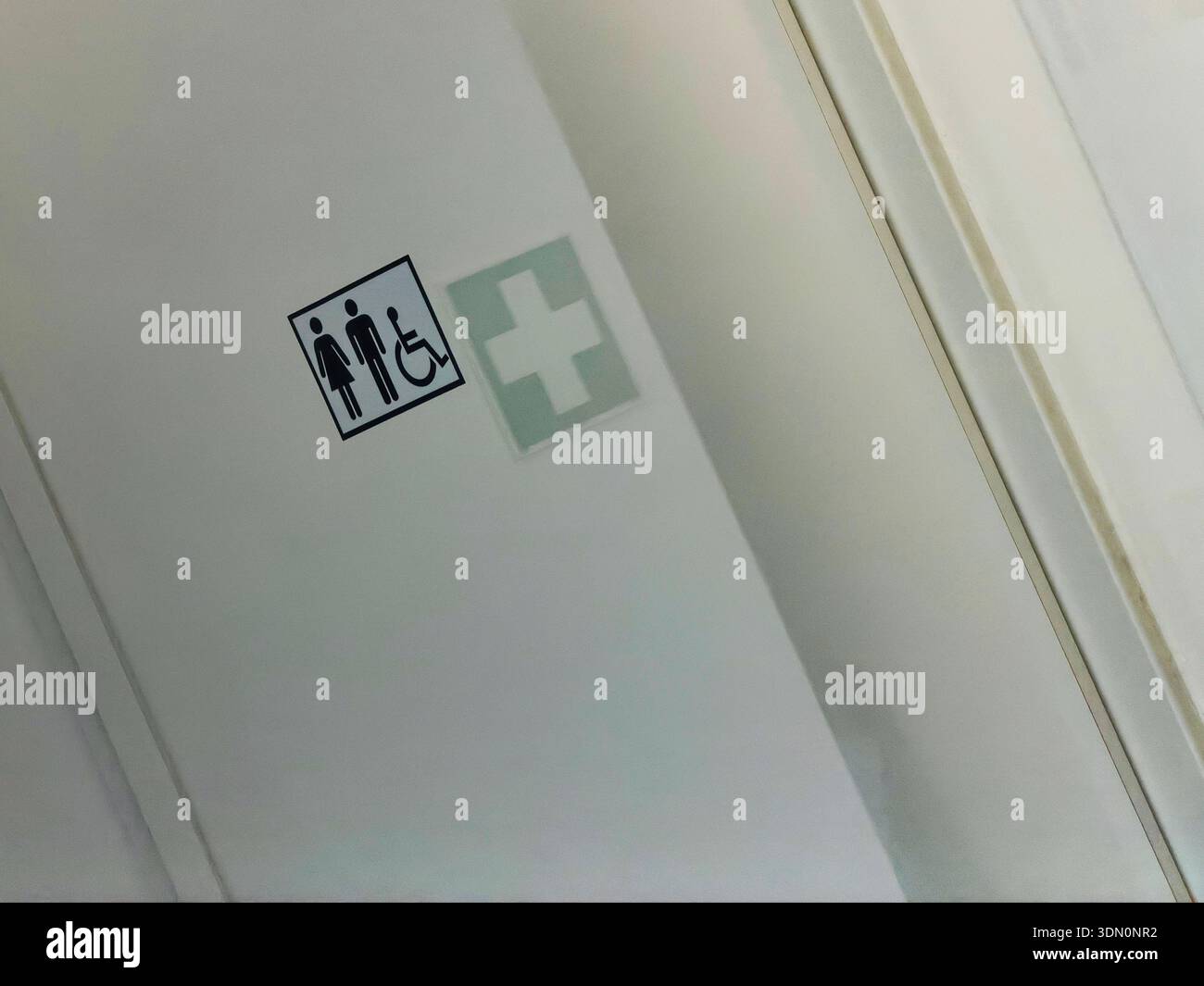 Restroom sign with wheelchair accessibility symbol on a clean interior ...
