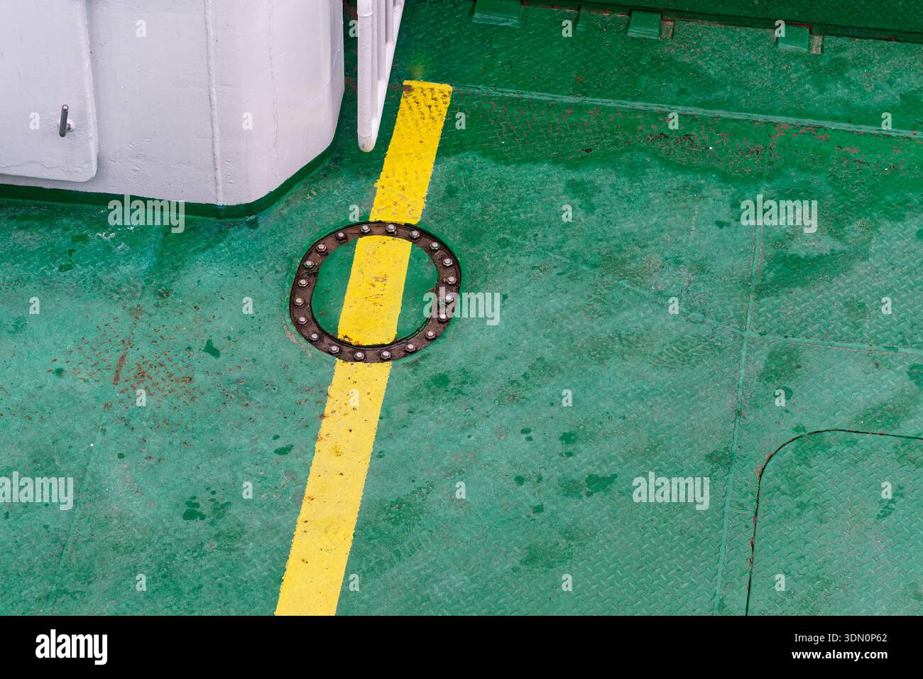 A green painted deck surface shows a straight yellow marking line ...