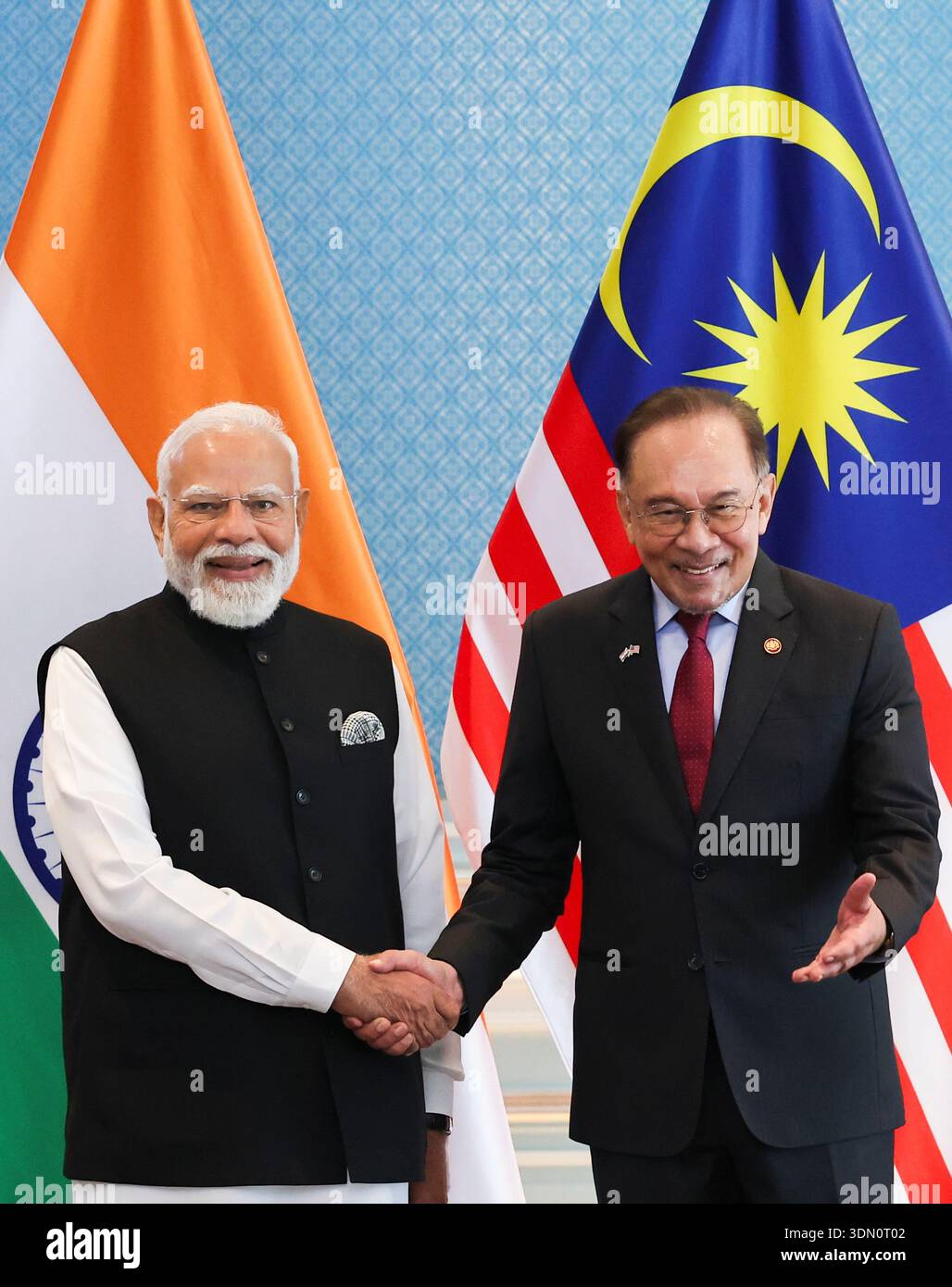 Malaysian Prime Minister Anwar Ibrahim, right, shakes hands with India ...