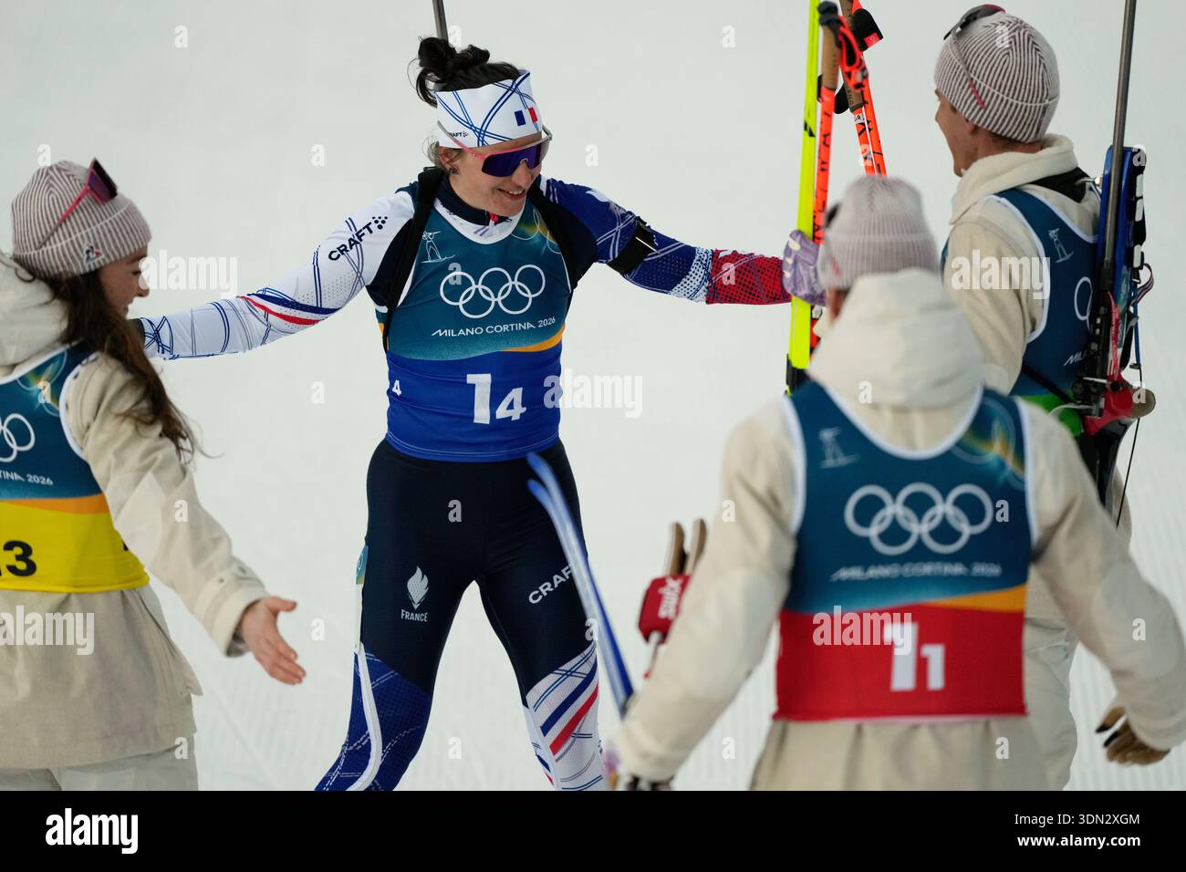 Julia Simon, of France, second from left, greets her teammates after ...