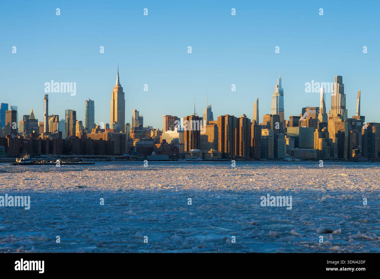 View Of A City Skyline With Golden Sunlight Reflecting Off The