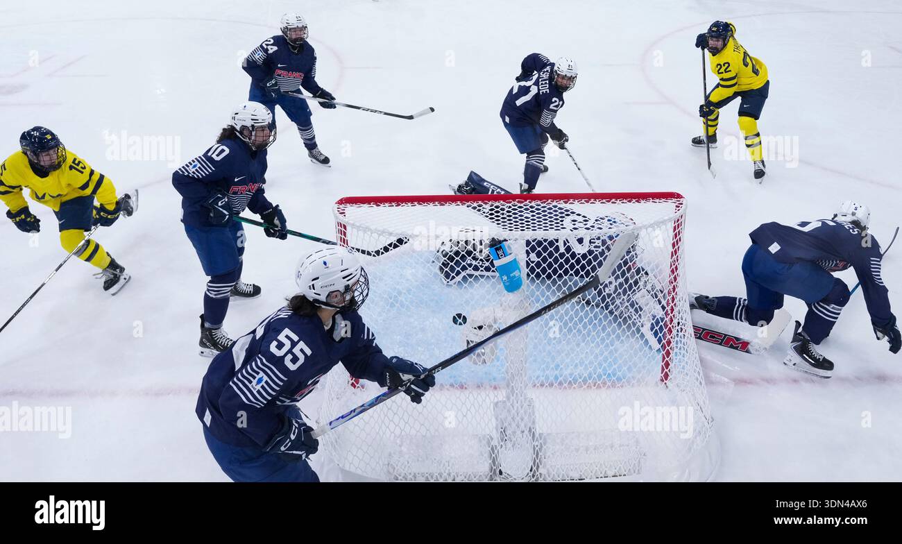 Goalkeeper Alice Philbert, center, of France fails to save the puck ...