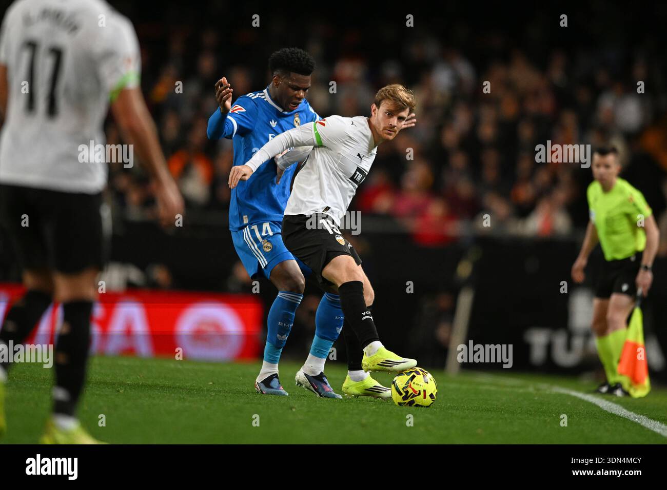 Valencia's Lucas Beltran, right, and Real Madrid's Aurelien Tchouameni ...
