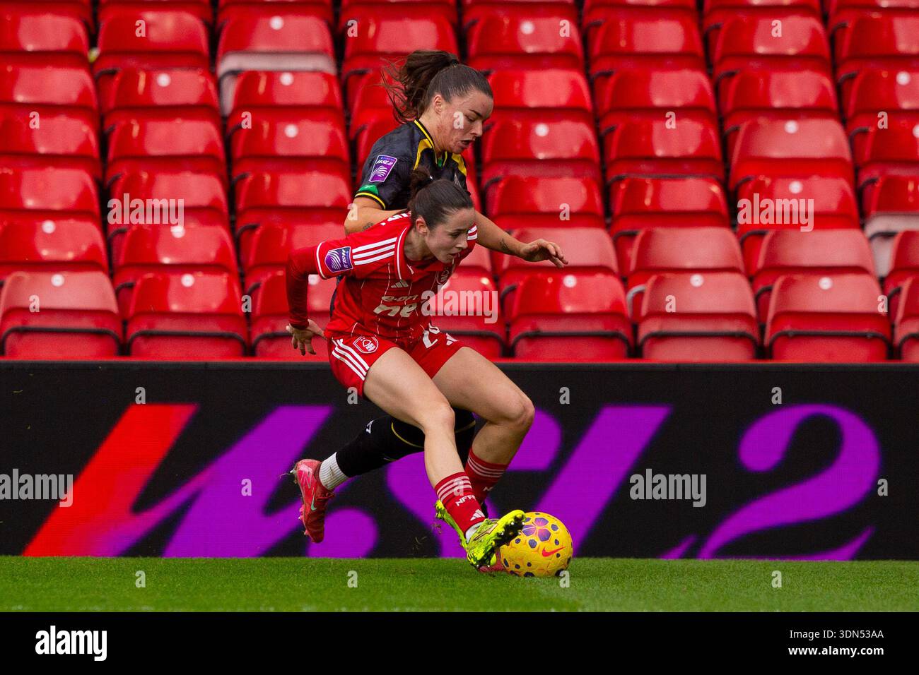 Cerys Brown (24 Nottingham Forest) shields the ball from Jodie Hutton ...
