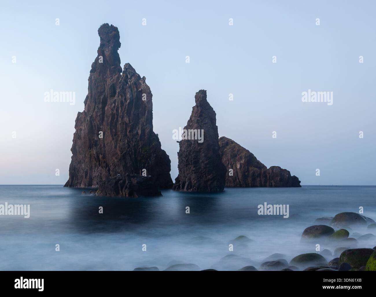 Sea stacks at Porto Moniz. Tall volcanic rock pinnacles rise from the ...