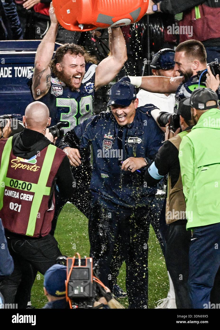 Seattle Seahawks head coach Mike MacDonald gets drenched at the end of ...