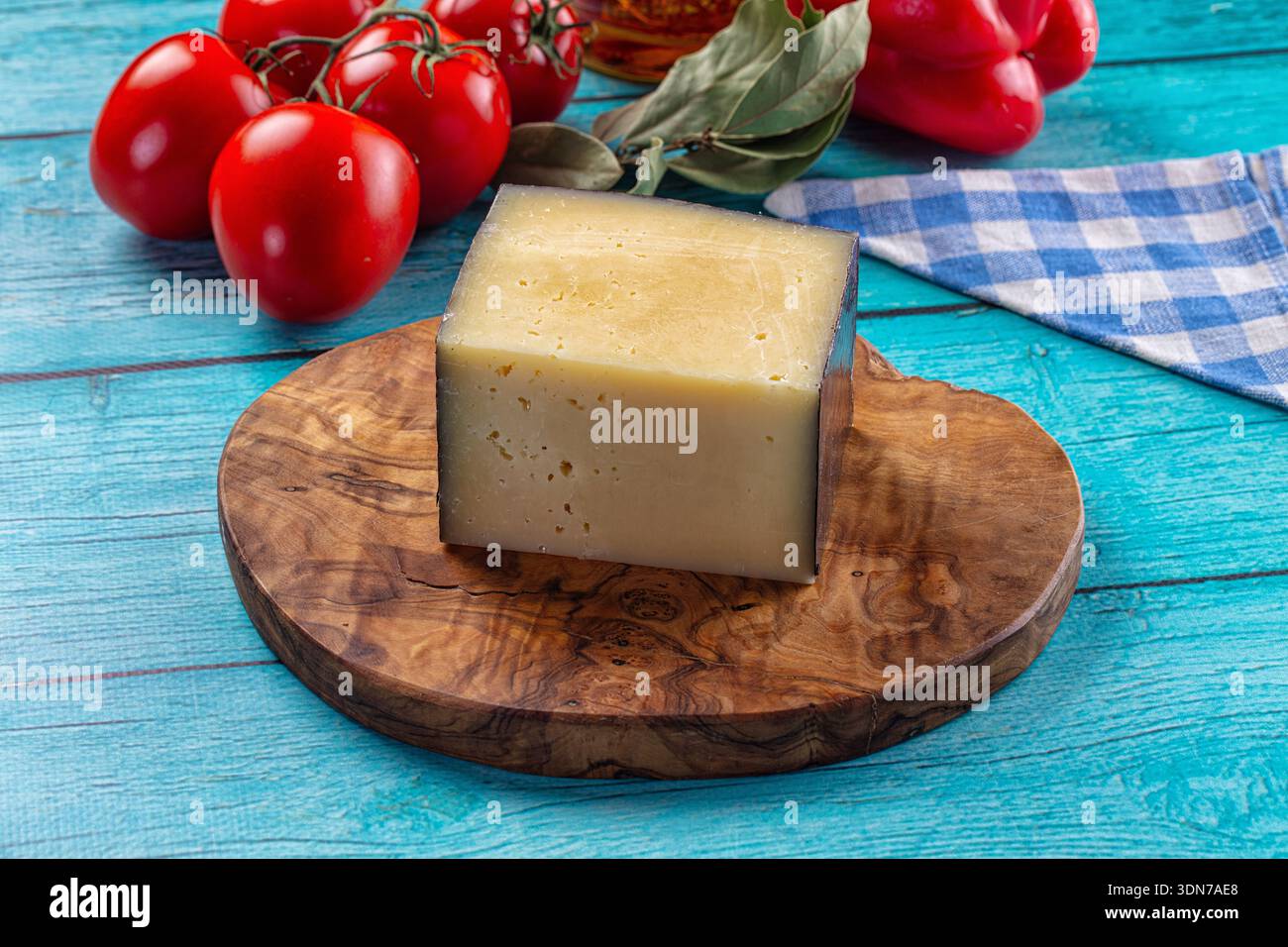 Gourmet hard parmesan cheese brick over board Stock Photo - Alamy