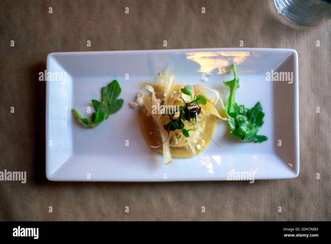 Overhead view of plated ravioli with garnish on top Stock Photo - Alamy
