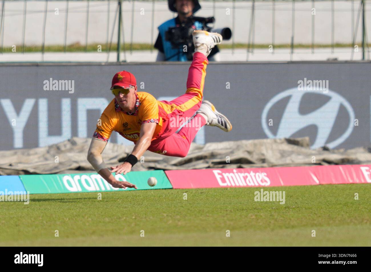 Zimbabwe's Bradley Evans successfully dives to stop a boundary during ...