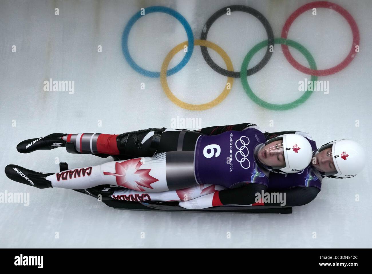 Canada's Beattie Podulsky, left, and Kailey Allan, right, slide down ...