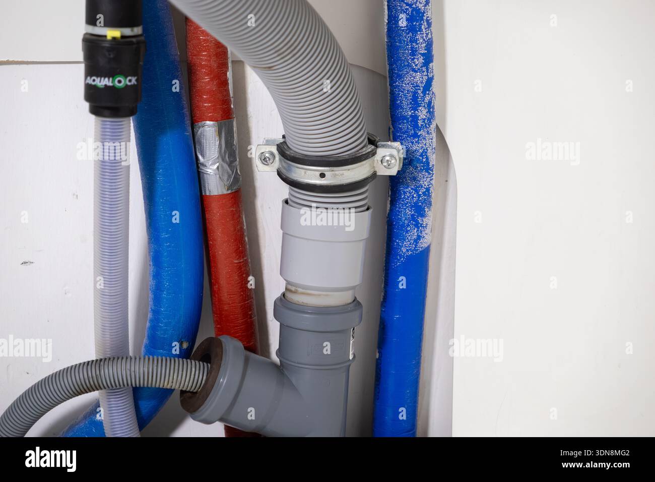 Close-up view of a residential plumbing setup with insulated water ...