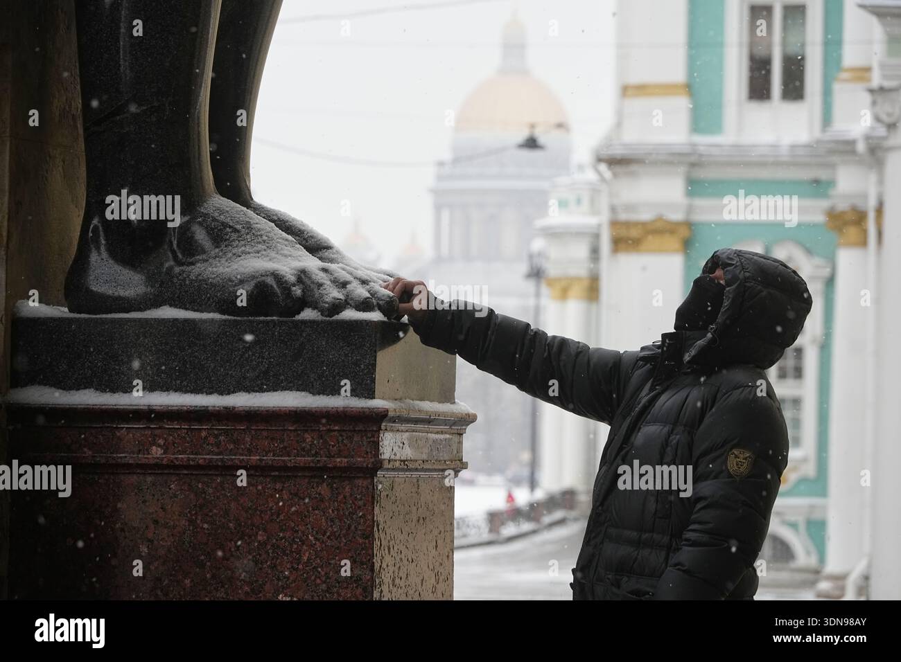 A man looks at one of the ten famous statues of Atlantes at the State ...