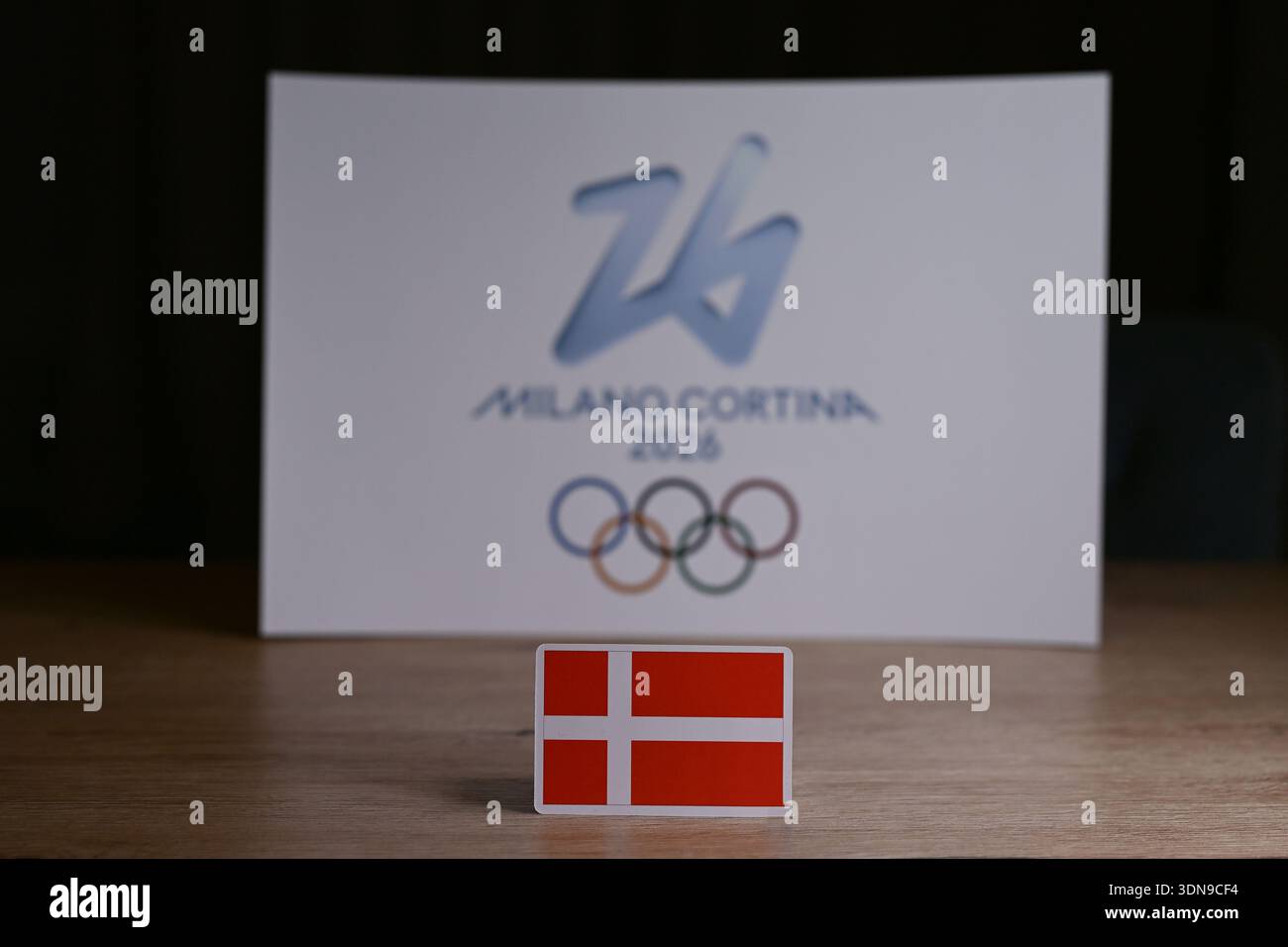 February 9, 2026. Milan, Italy. The flag of Denmark on the background ...