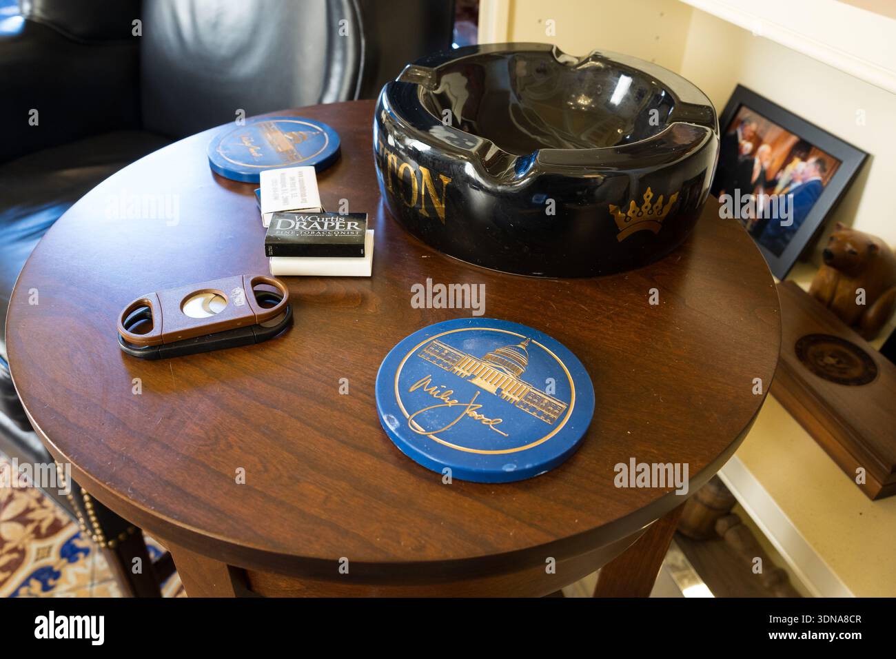 A cigar cutter, matches, an ashtray, and coasters are seen in the ...
