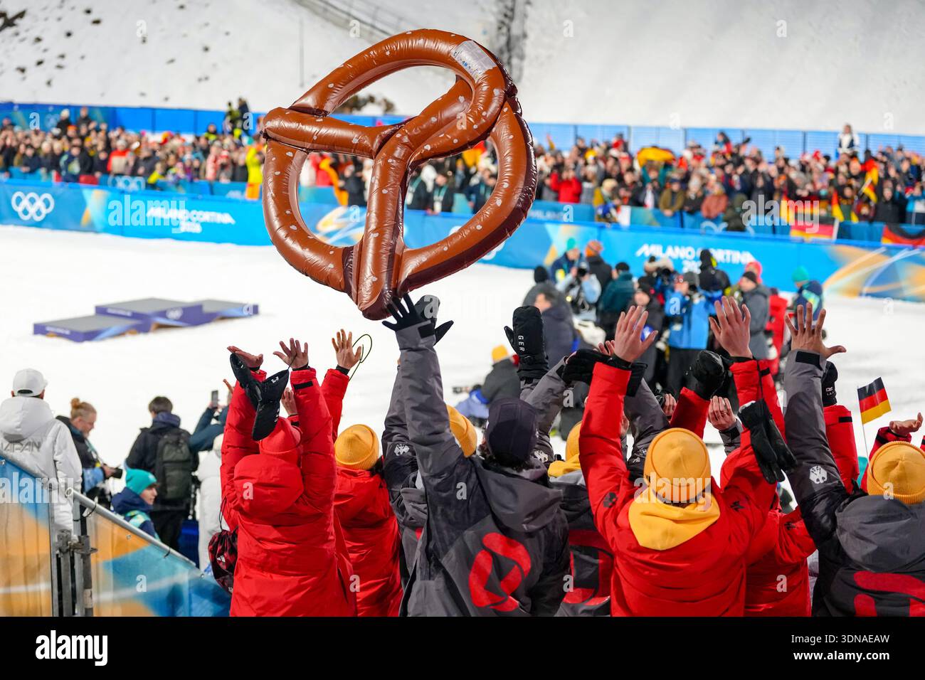 The German team throws an inflatable pretzel in the air during the ...