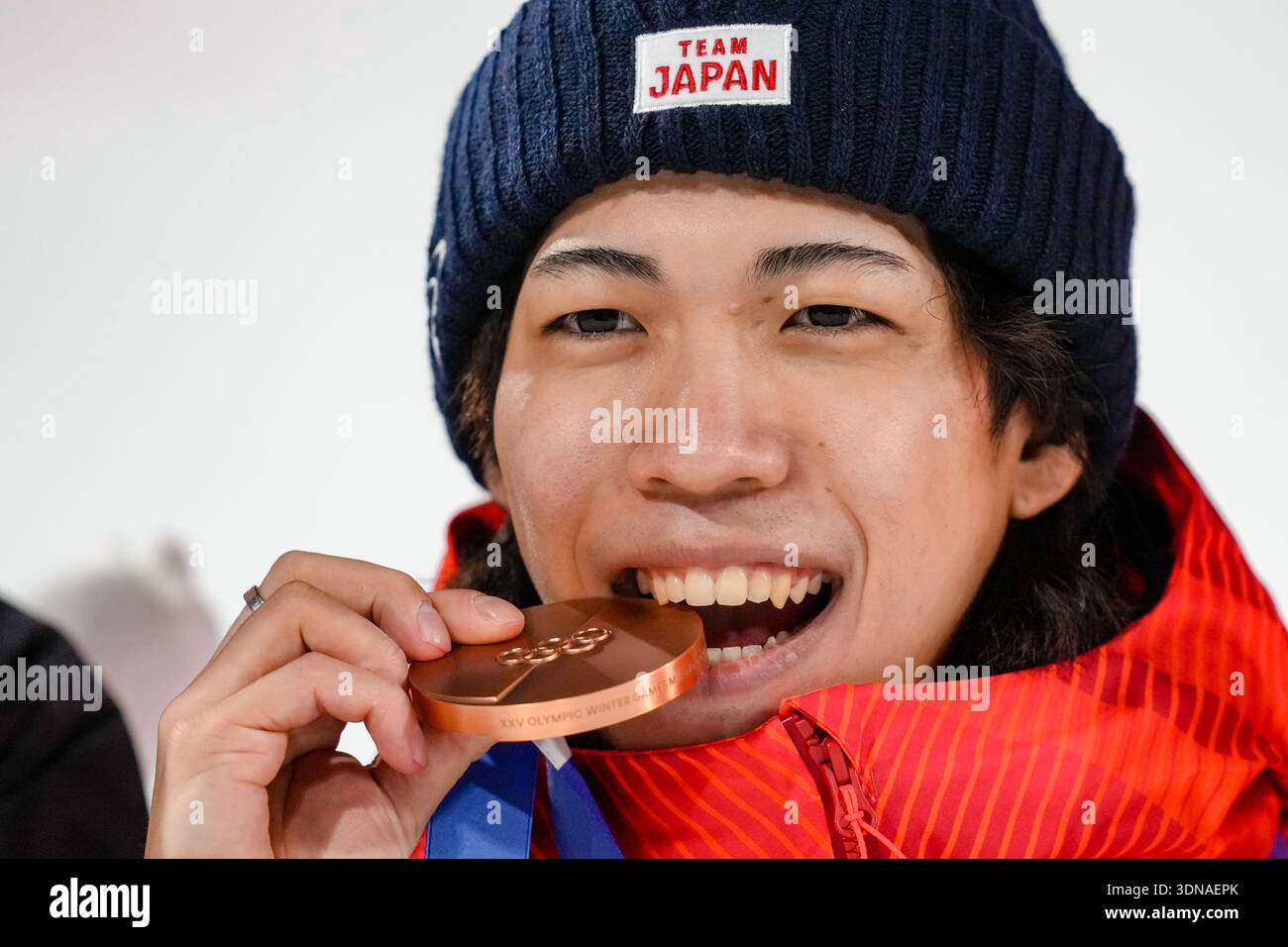 Ren Nikaido, of Japan, poses after winning the bronze medal in the ski ...