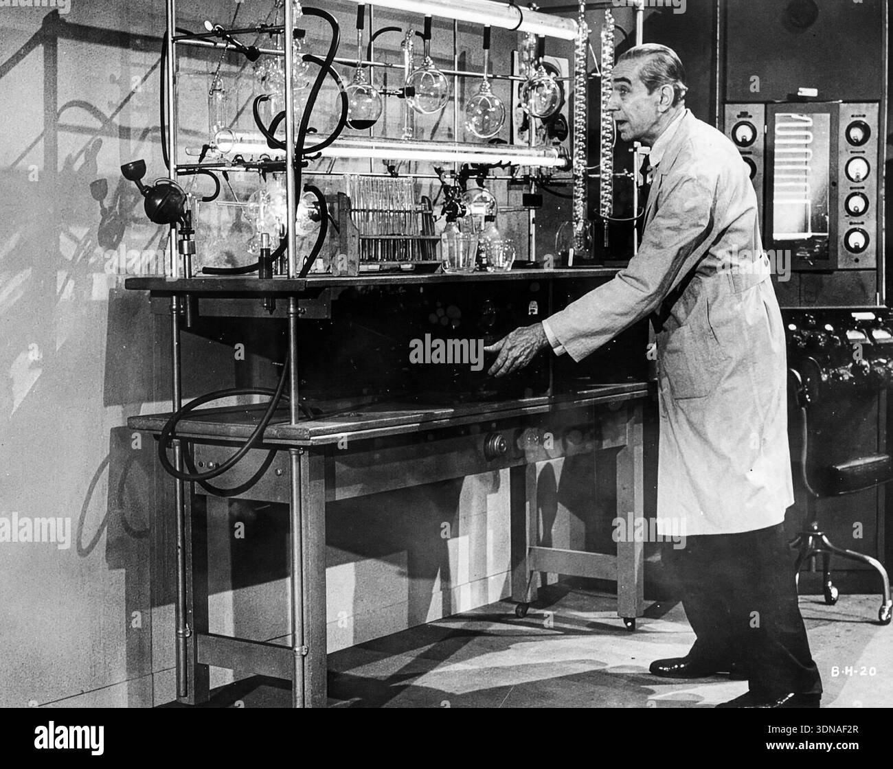 Bela Lugosi, portraying a mad scientist, works with intricate ...