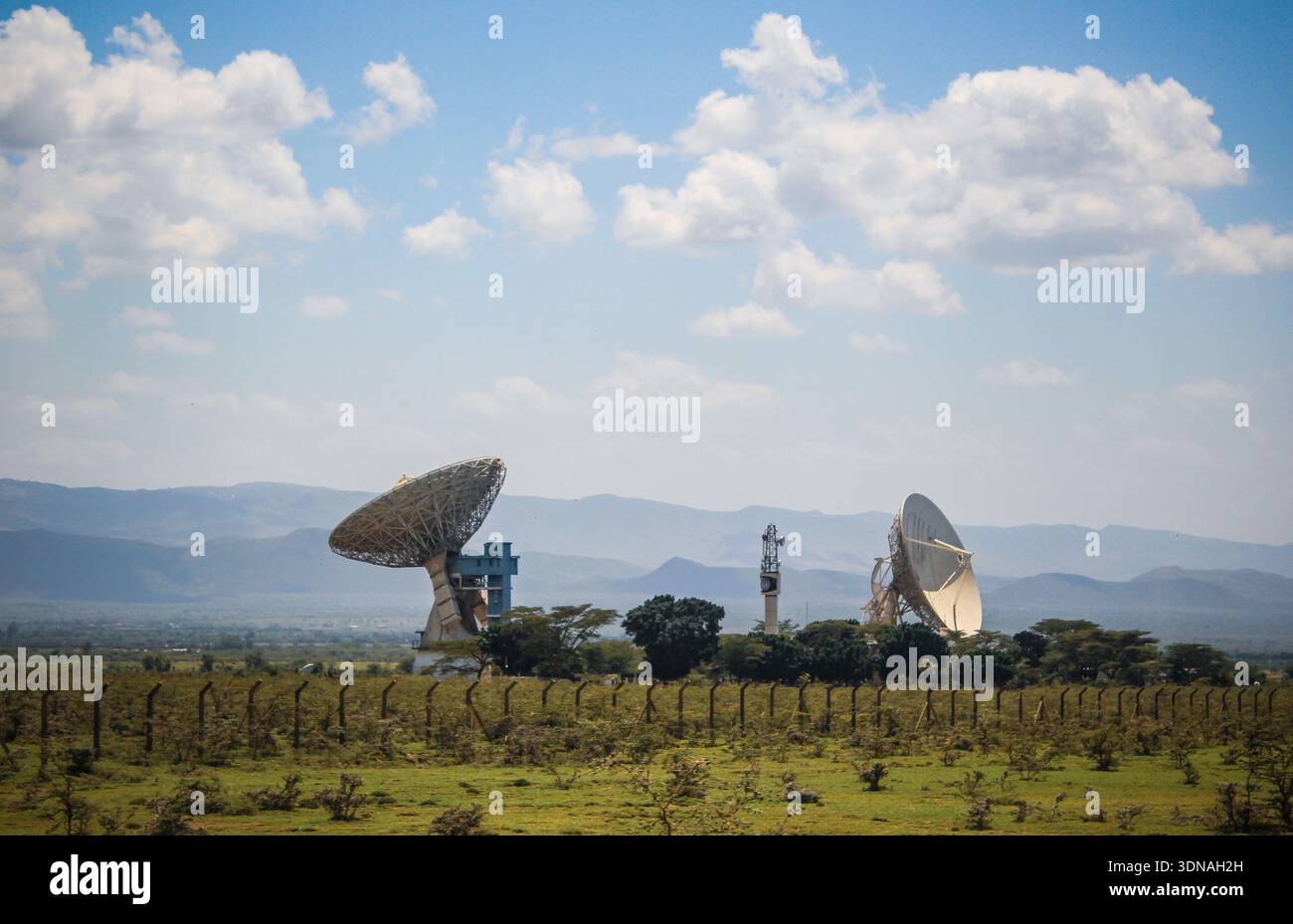 Large satellite dishes and communication towers in rural Kenya, set ...