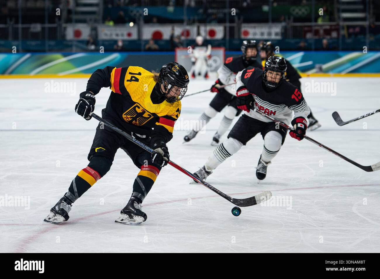 Carina Strobel (14) of Germany controls the puck during a women’s ...