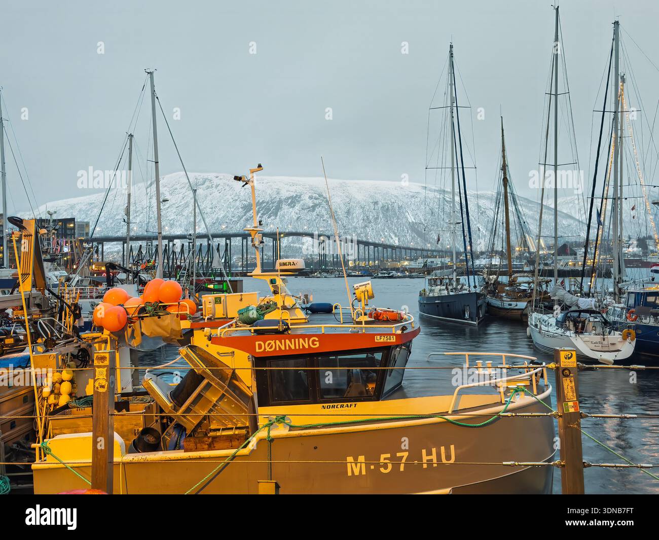 Tromso, Norway - December 23, 2025: View on bridge and snow-covered ...