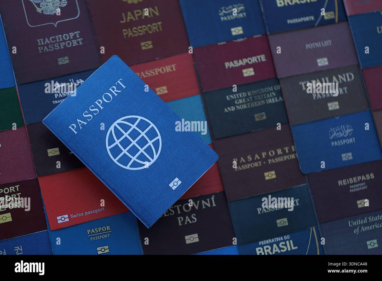 Fictional passport book travel document on big amount of real passport ...