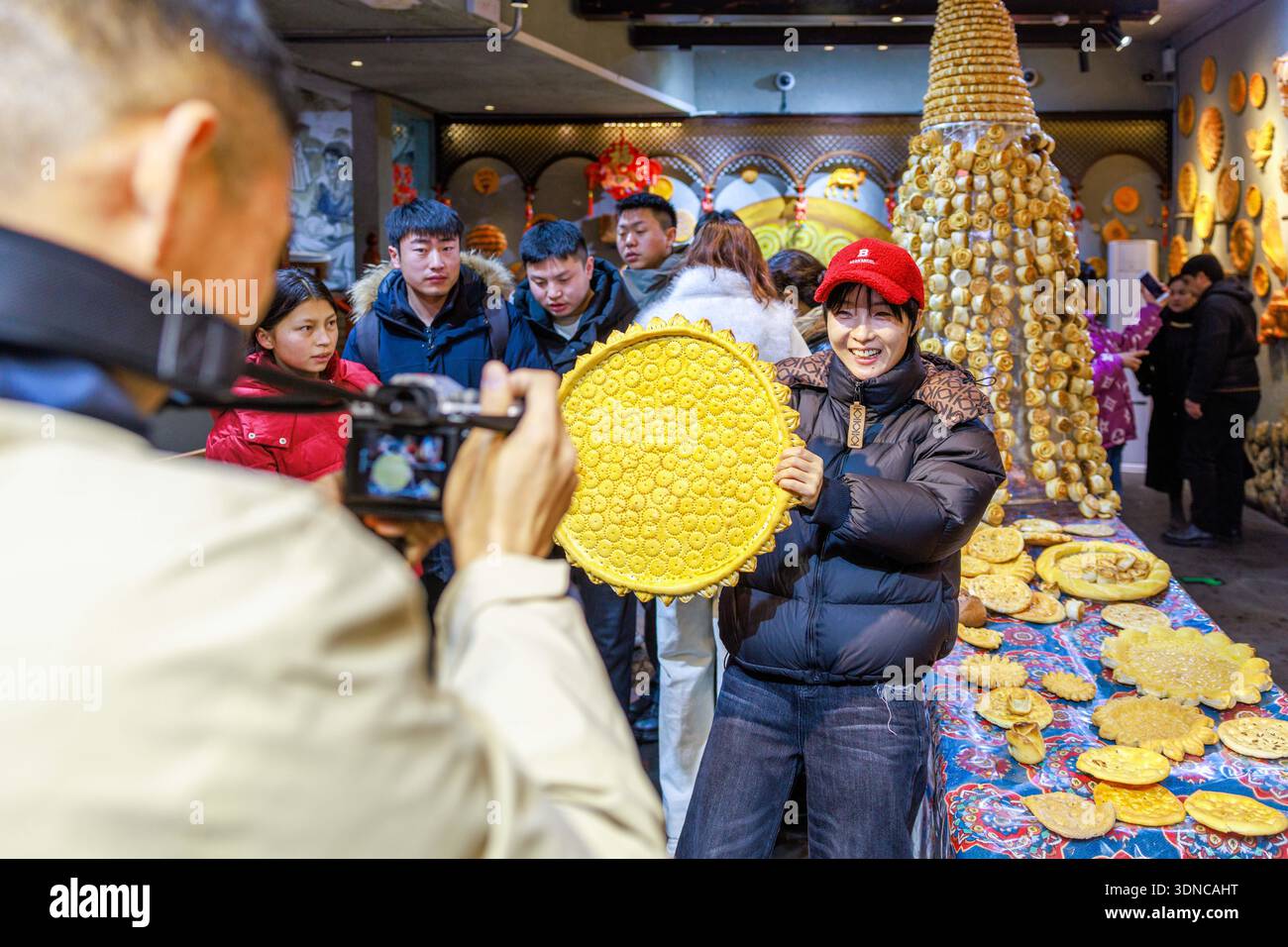Tourists take photos at the Grand Bazaar pedestrian street in Urumqi ...