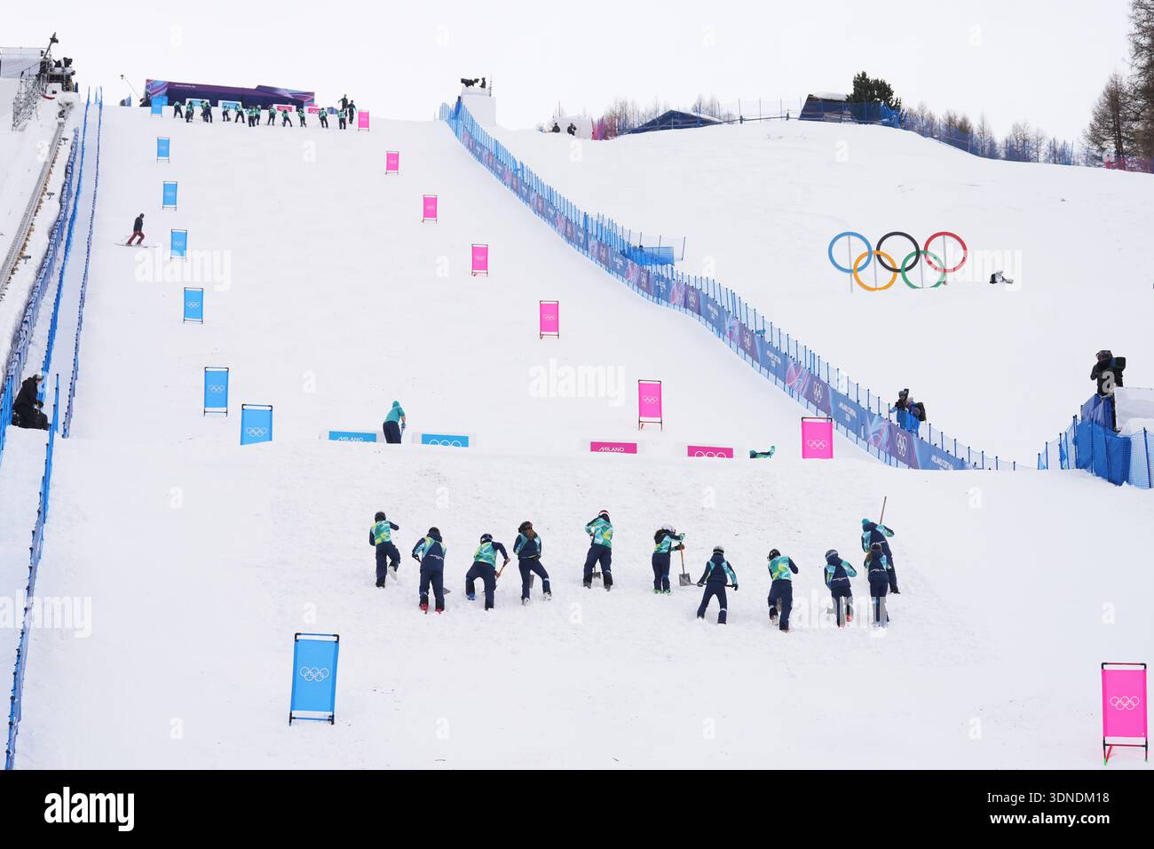 Workers prep the freestyle skiing moguls course after men's ...